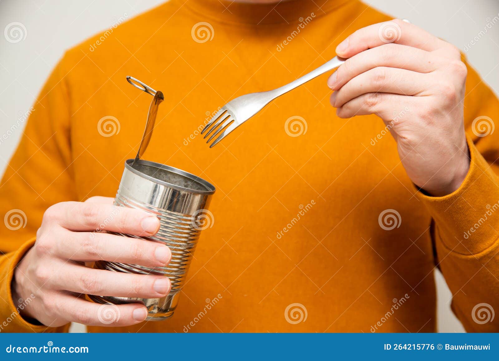Man Holding a Fork and Opened Tin Can Stock Photo - Image of orange ...