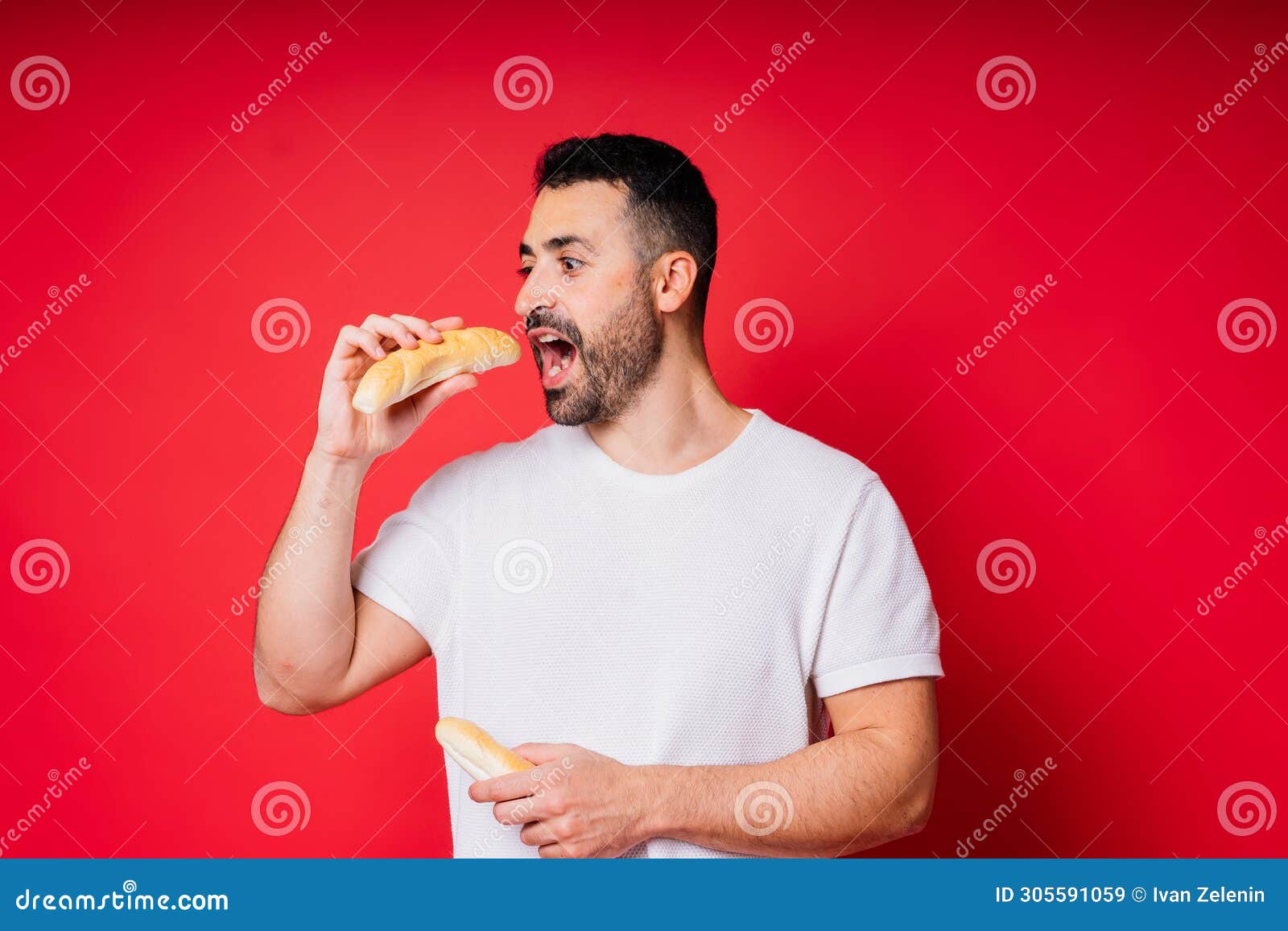 Man Holding Freshly Baked Bread in Hands Isolated on Red Background ...