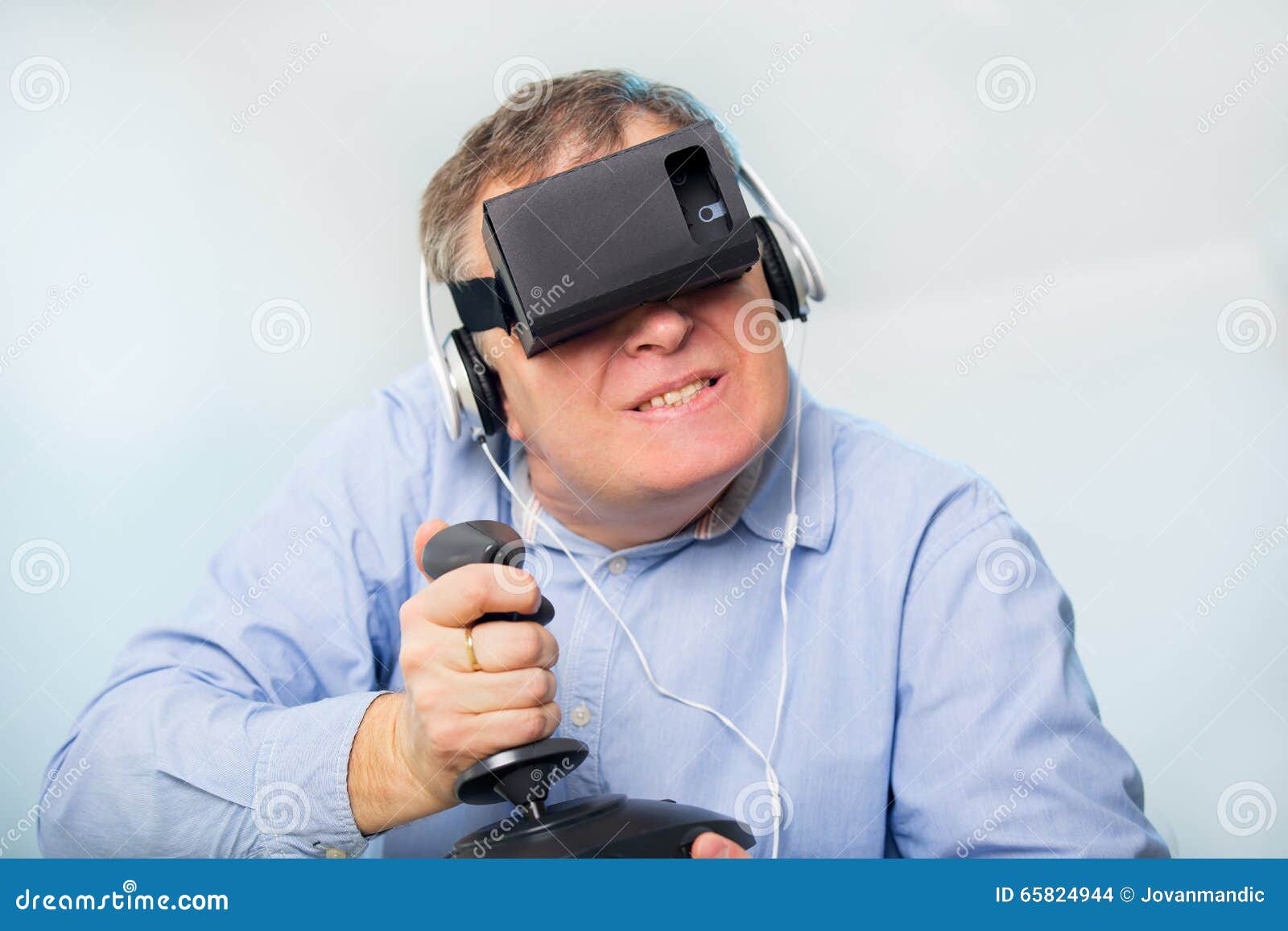 Man Holding a Gaming Computer Wheel Getting Experience Using VR-headset ...