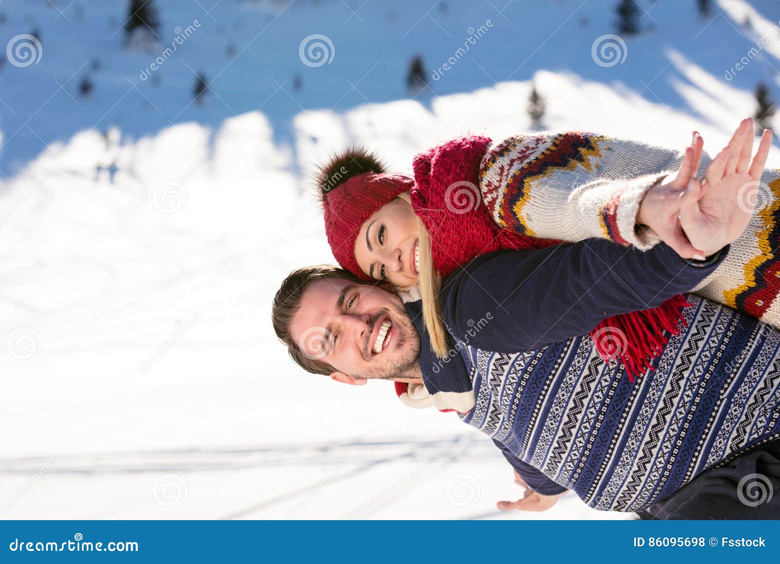 Man Holding Girlfriend on His Back at the Top of Mountain Stock Photo ...