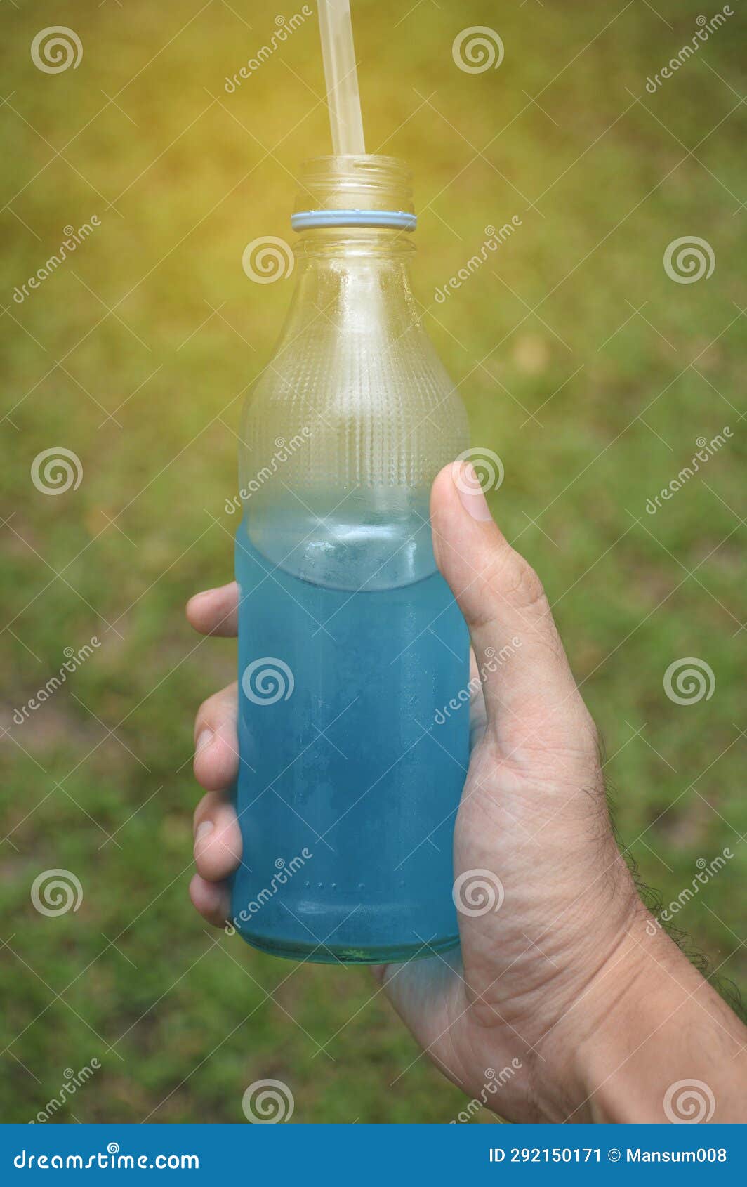 A Man Holding a Glass Bottle with Blue Liquid Stock Image - Image of ...