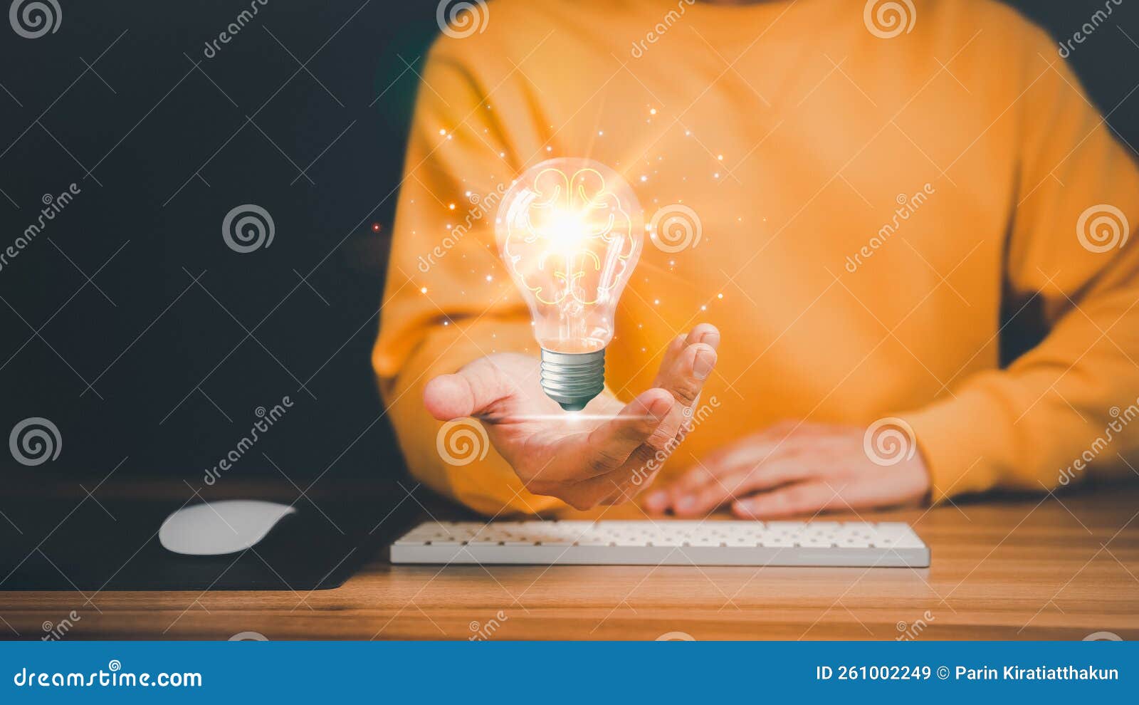 Man Holding a Glowing Abstract Light Bulb with a Computer Keyboard on ...