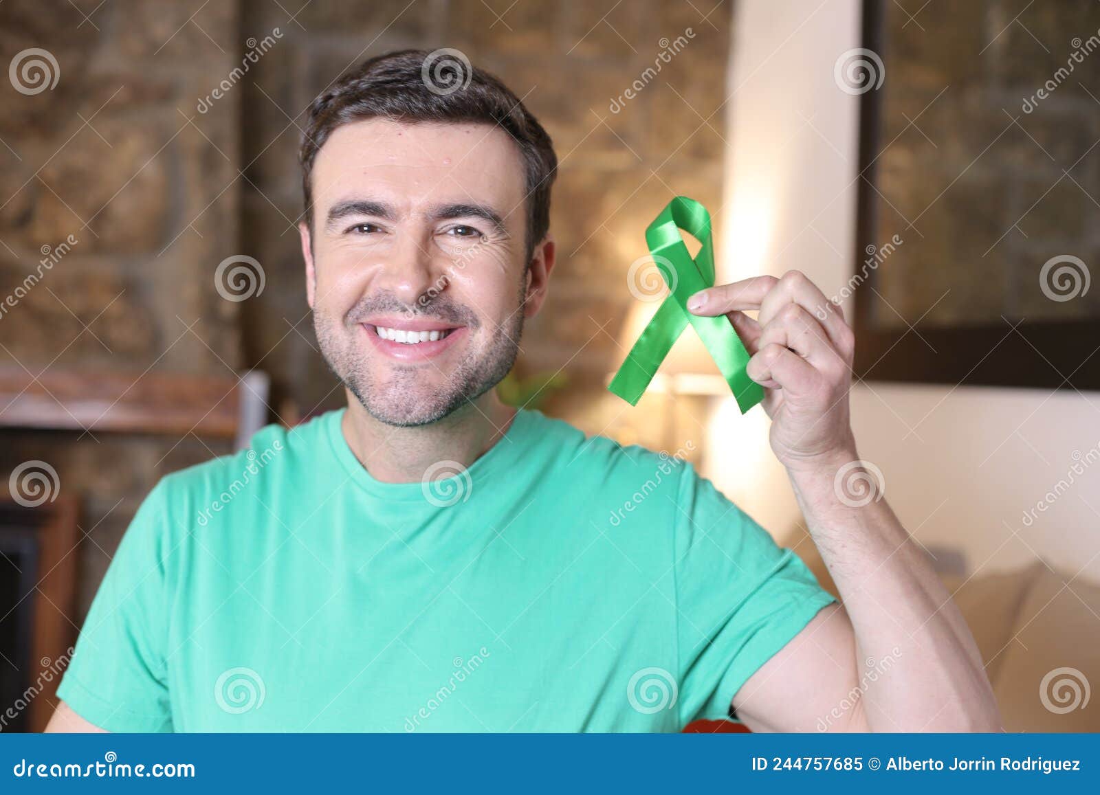 Man holding a green ribbon stock image. Image of hand - 244757685