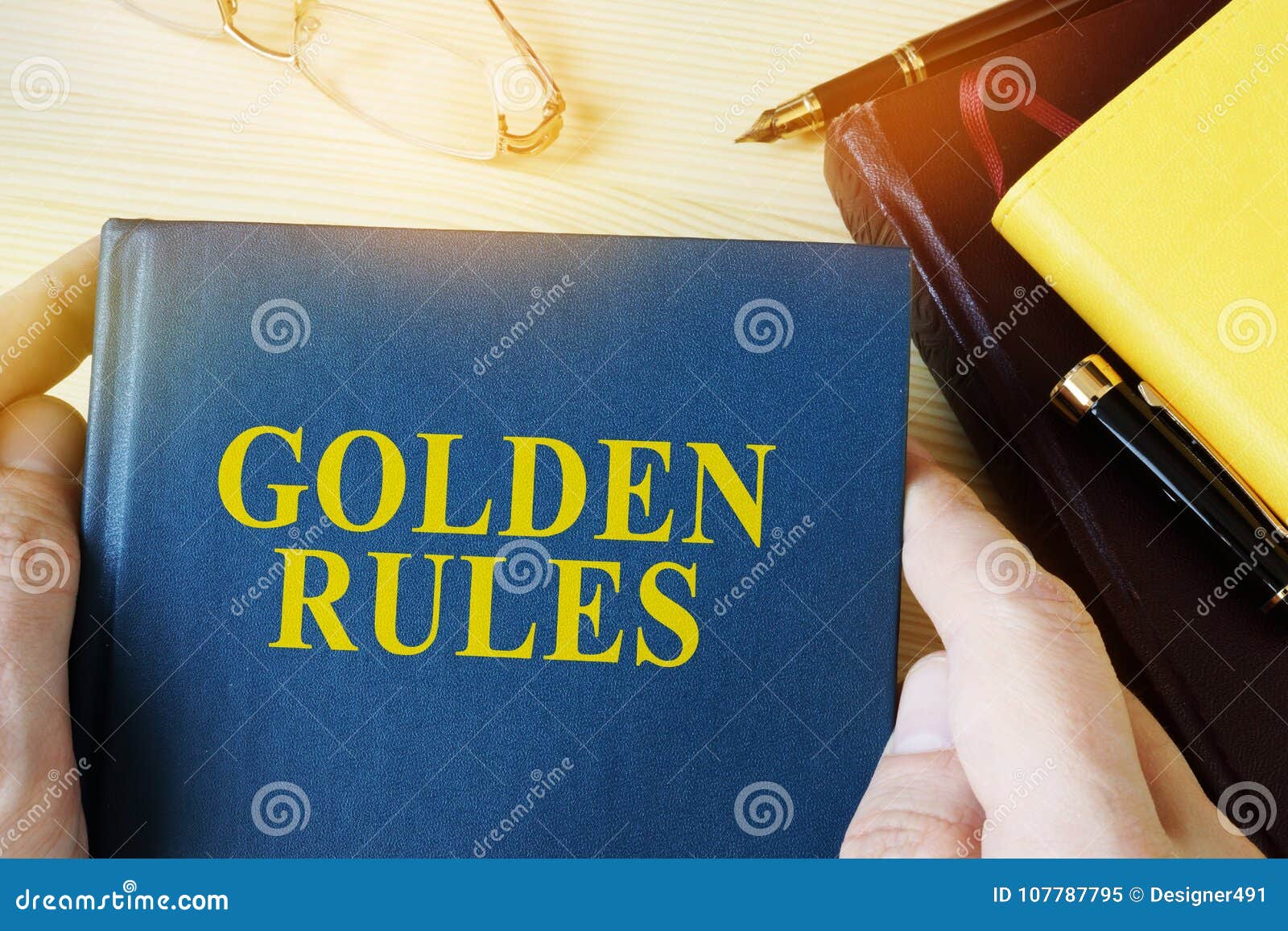 Man Holding Guide with Title Golden Rules. Stock Image - Image of ...