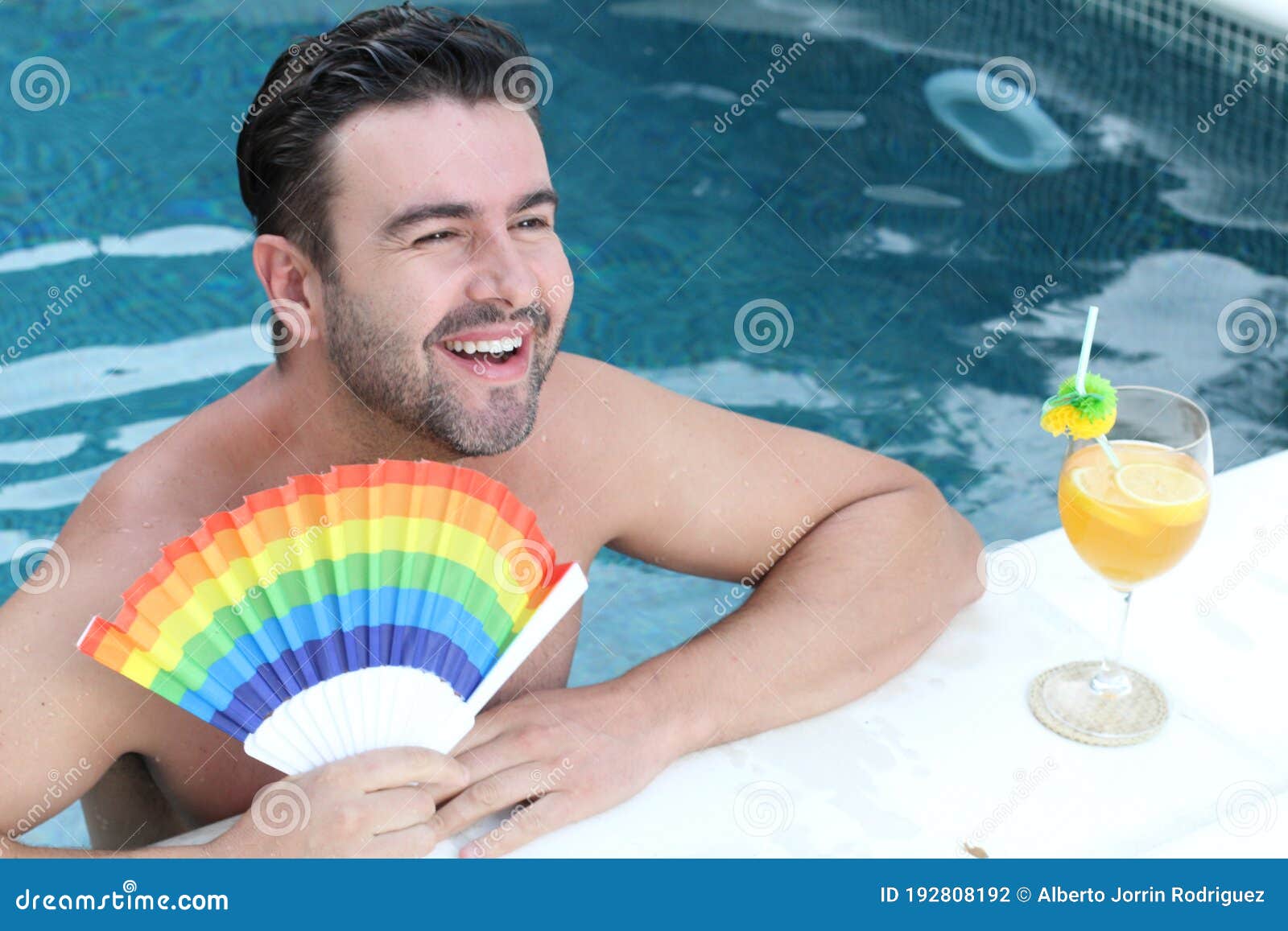 Man Holding Hand Fan with Rainbow Flag in Swimming Pool Stock Photo ...