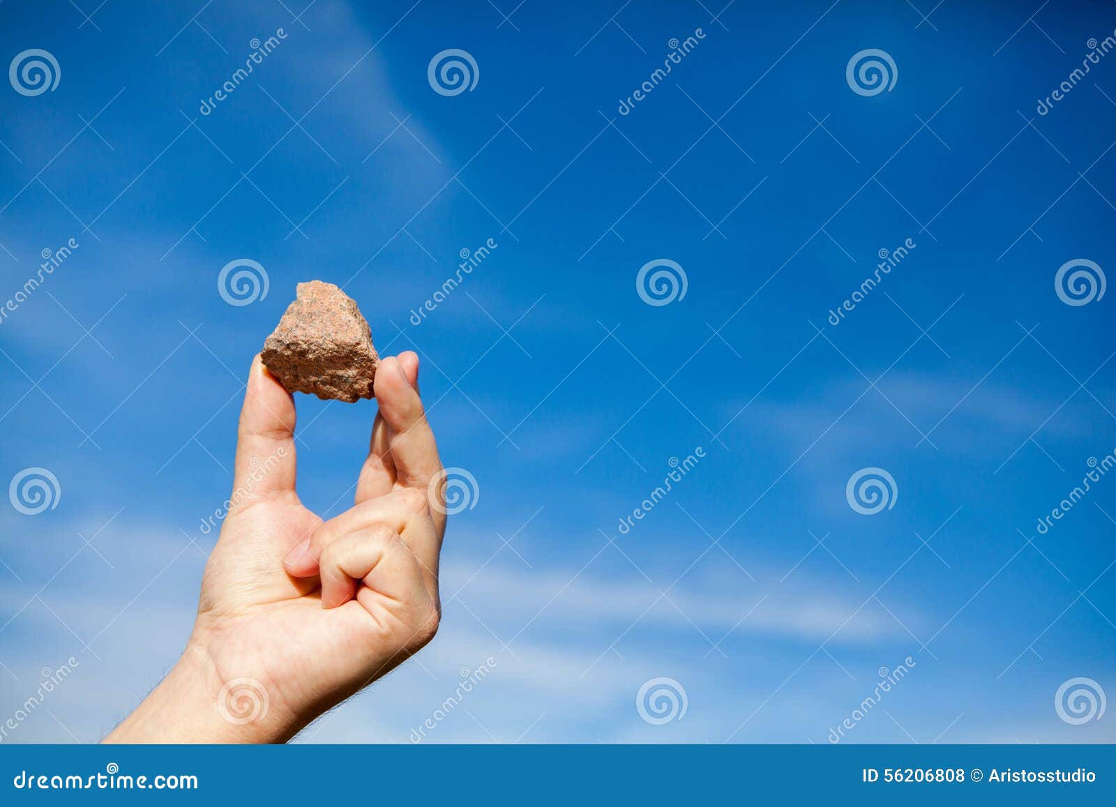 Man Holding in Hand Rock on Blue Sky Stock Photo - Image of balance ...