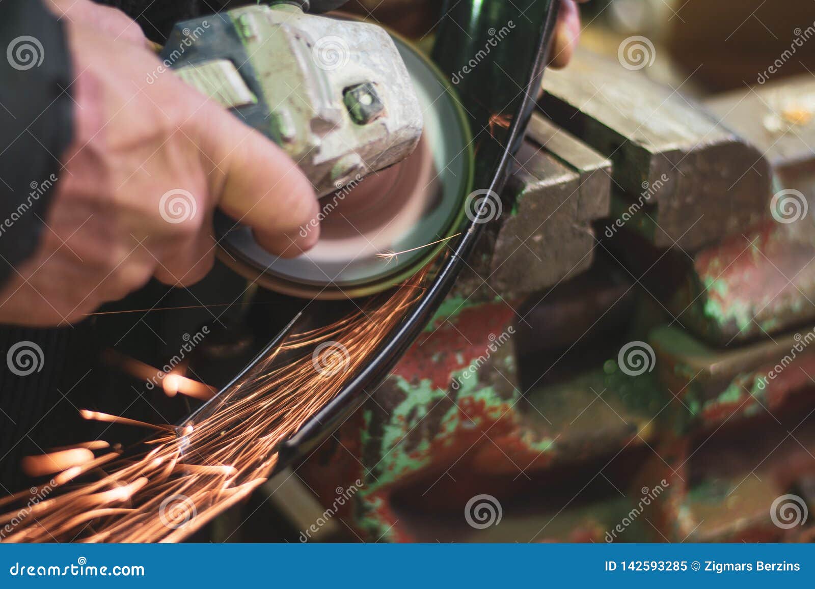 Man Holding in Hands Peace of Metal and Grinds it with Sparkles Stock ...