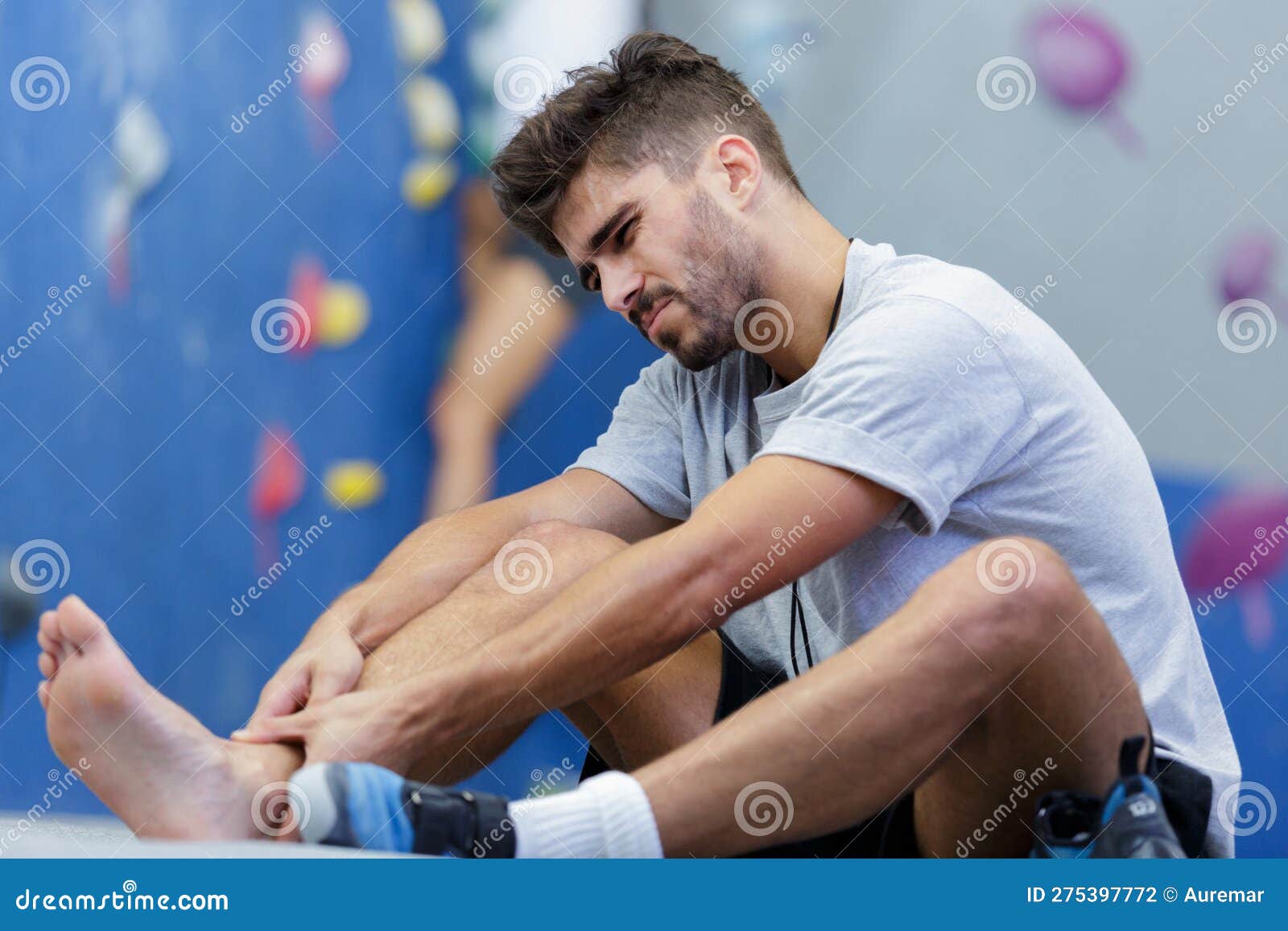 Man holding ankle in pain stock photo. Image of people - 275397772