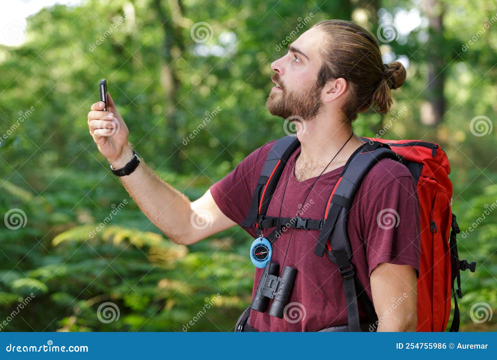 Man Holding Phone Out in Woods Stock Photo - Image of instrument, young ...