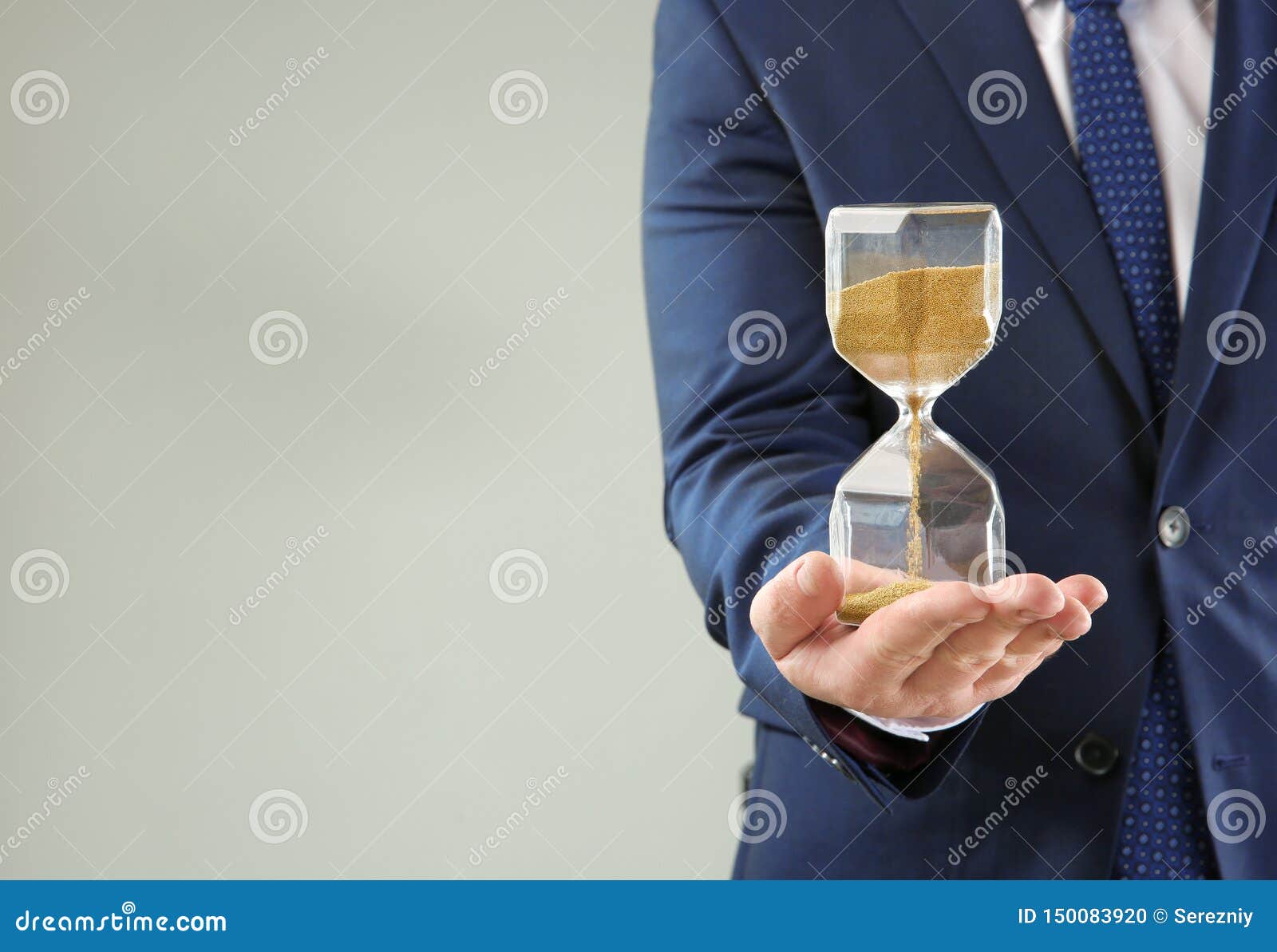Man Holding Hourglass on Grey Background. Time Management Concept Stock ...