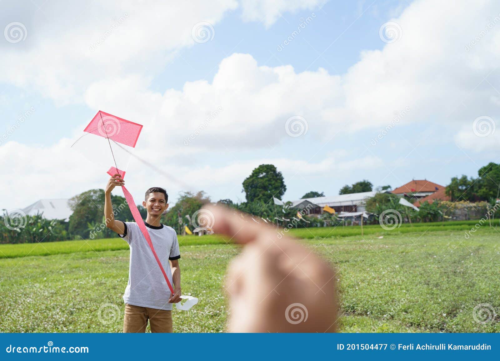 A man holding a kite stock image. Image of kites, ricefield - 201504477