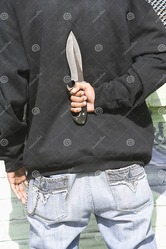 Man Holding Knife Behind Back Stock Image - Image of view, outlaw: 29665699