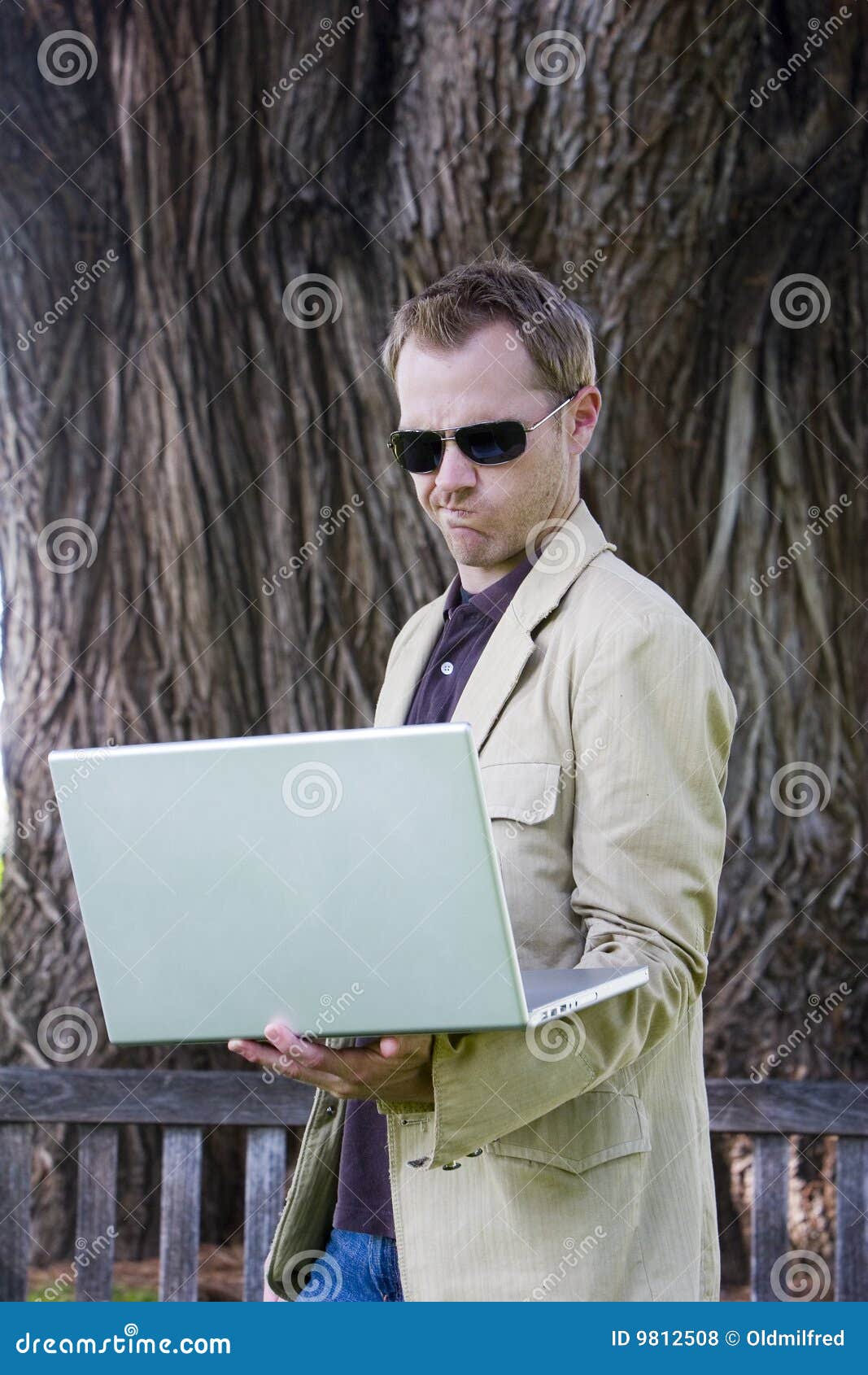 Man Holding Laptop Computer Stock Photo - Image of work, park: 9812508