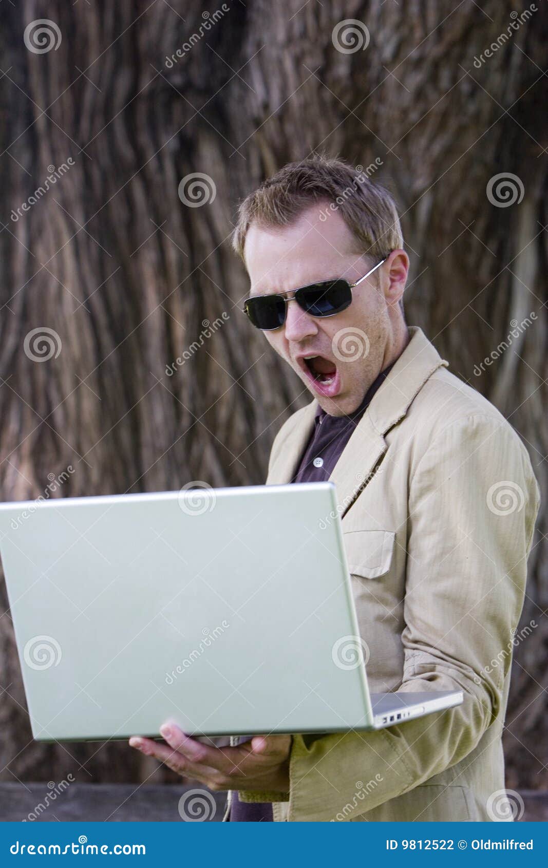 Man Holding Laptop Computer Stock Photo - Image of disbelief, young ...