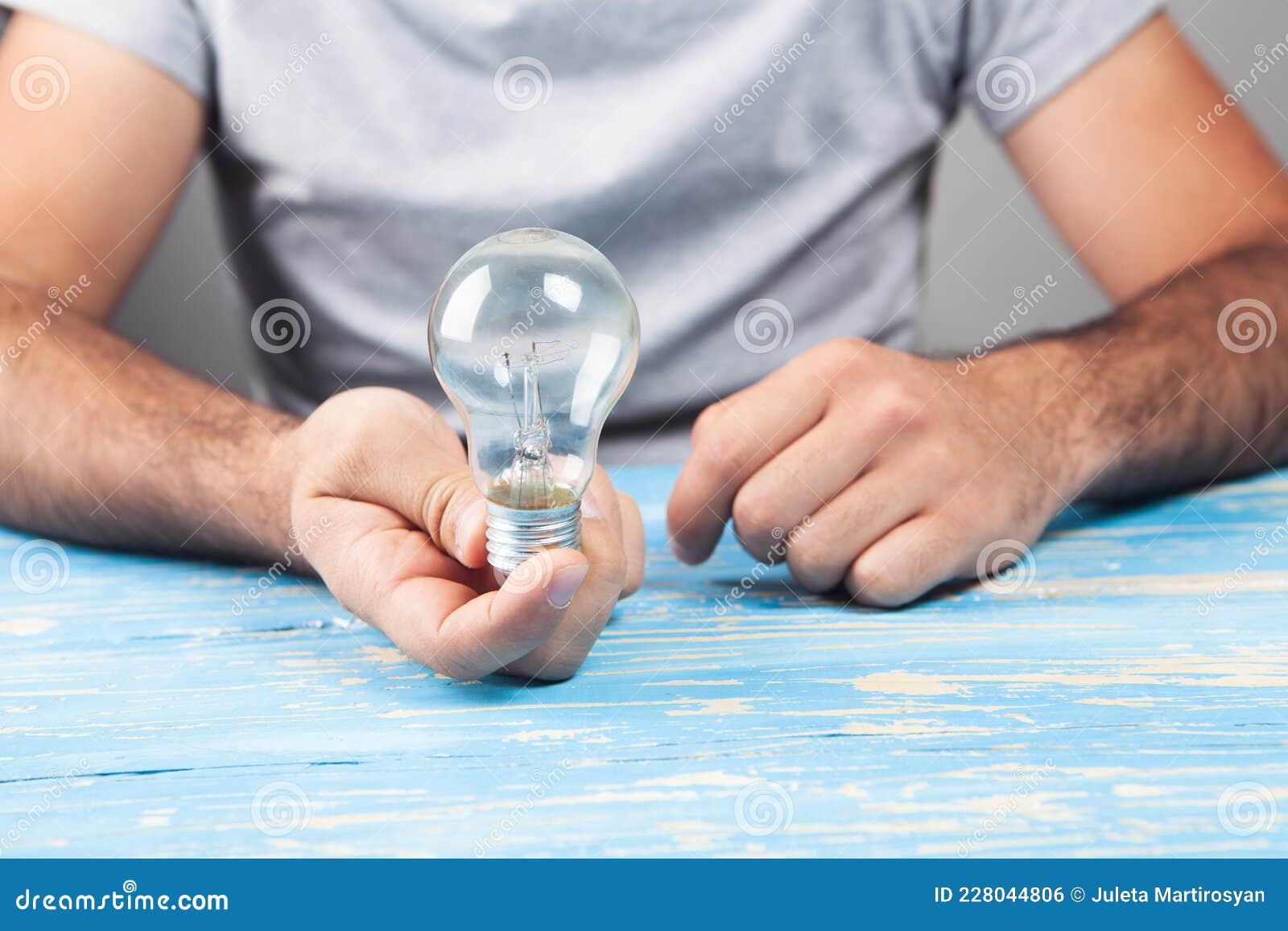 A man holding a light bulb stock photo. Image of background - 228044806