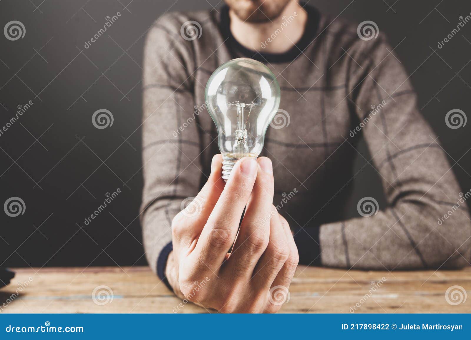 A man holding a light bulb stock photo. Image of knowledge - 217898422