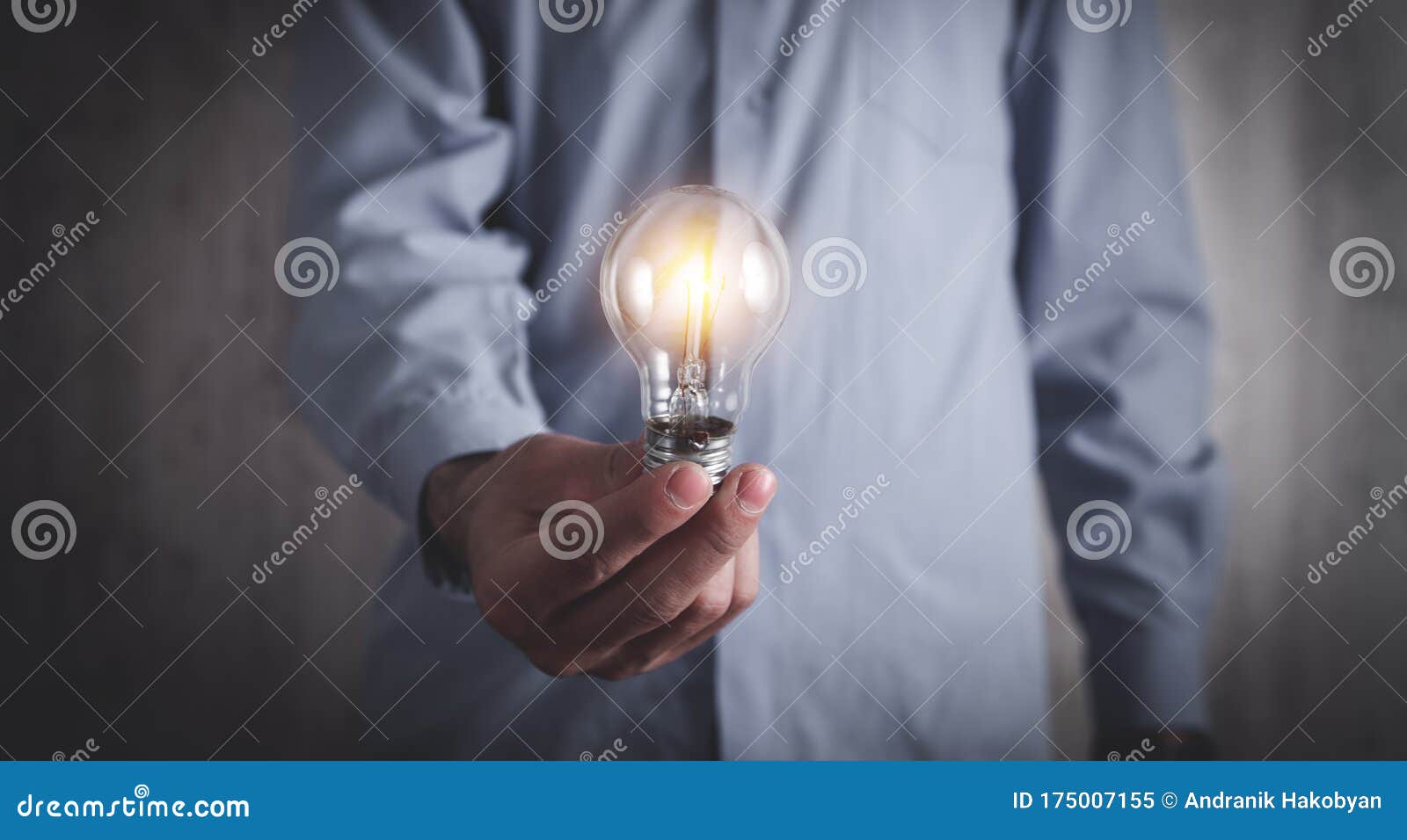 Man Holding Light Bulb. Concept of Inspiration and Creativity Stock ...