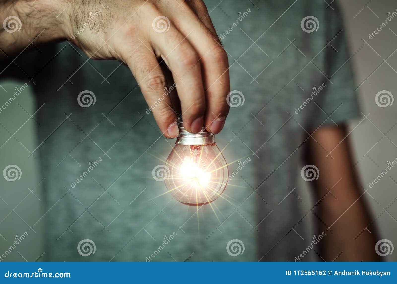 Man holding light bulb. stock photo. Image of invention - 112565162