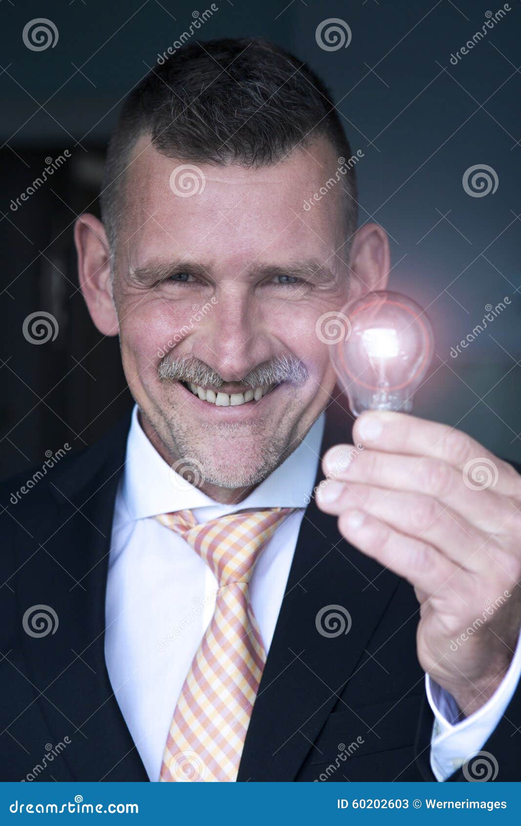 Man Holding a Lightbulb and Smiles Stock Image - Image of electricity ...