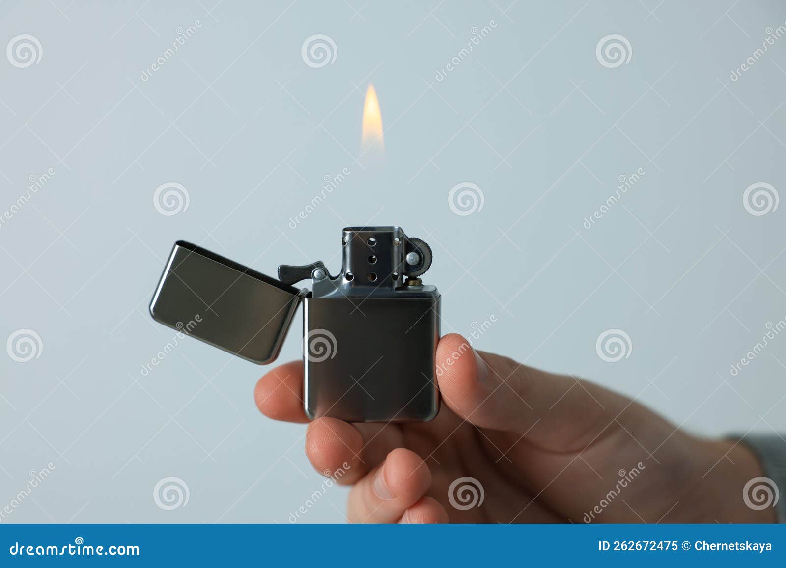 Man Holding Lighter with Burning Flame Against Light Grey Background ...