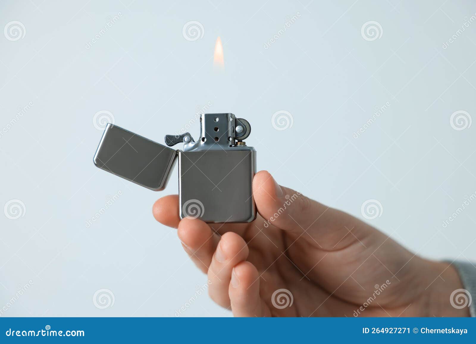 Man Holding Lighter with Burning Flame Against Light Grey Background ...