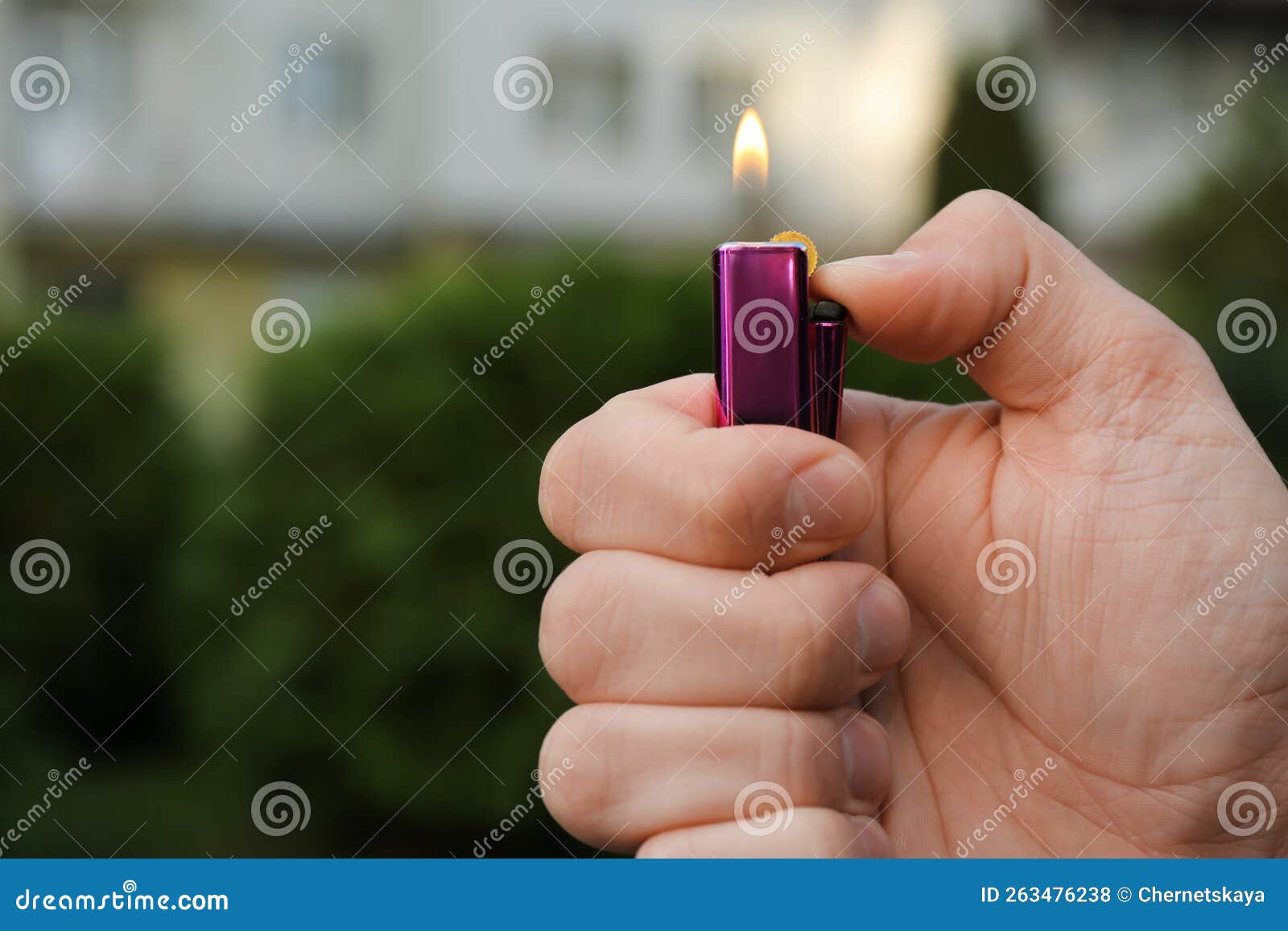 Man Holding Lighter with Burning Flame Outdoors, Closeup. Space for ...