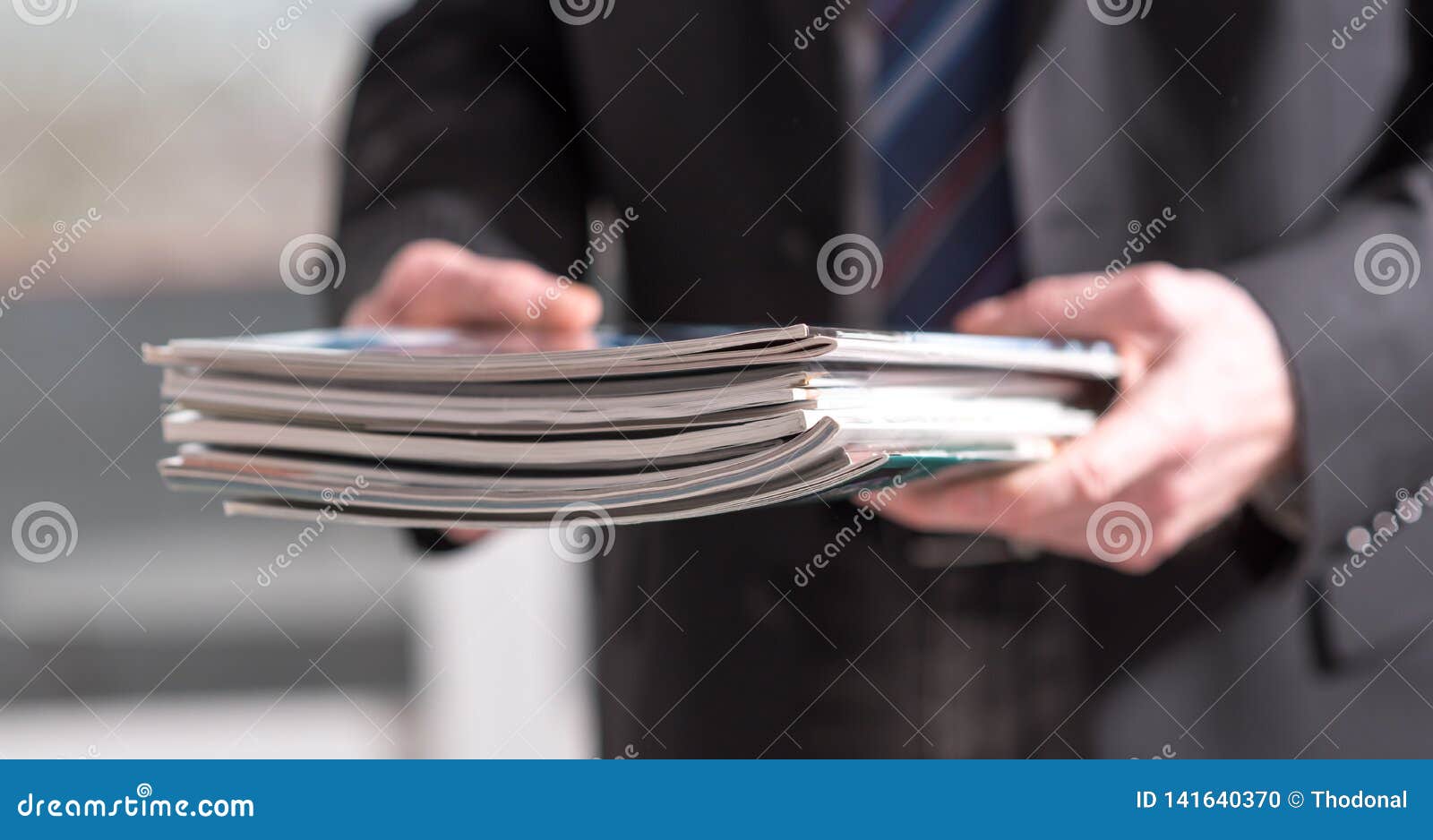 Man holding magazines stock photo. Image of journal - 141640370