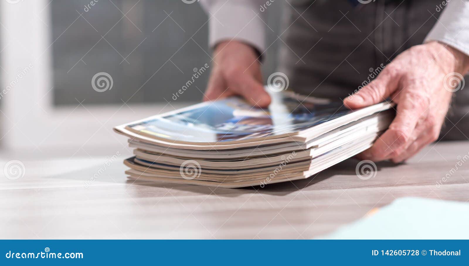 Man holding magazines stock photo. Image of publication - 142605728
