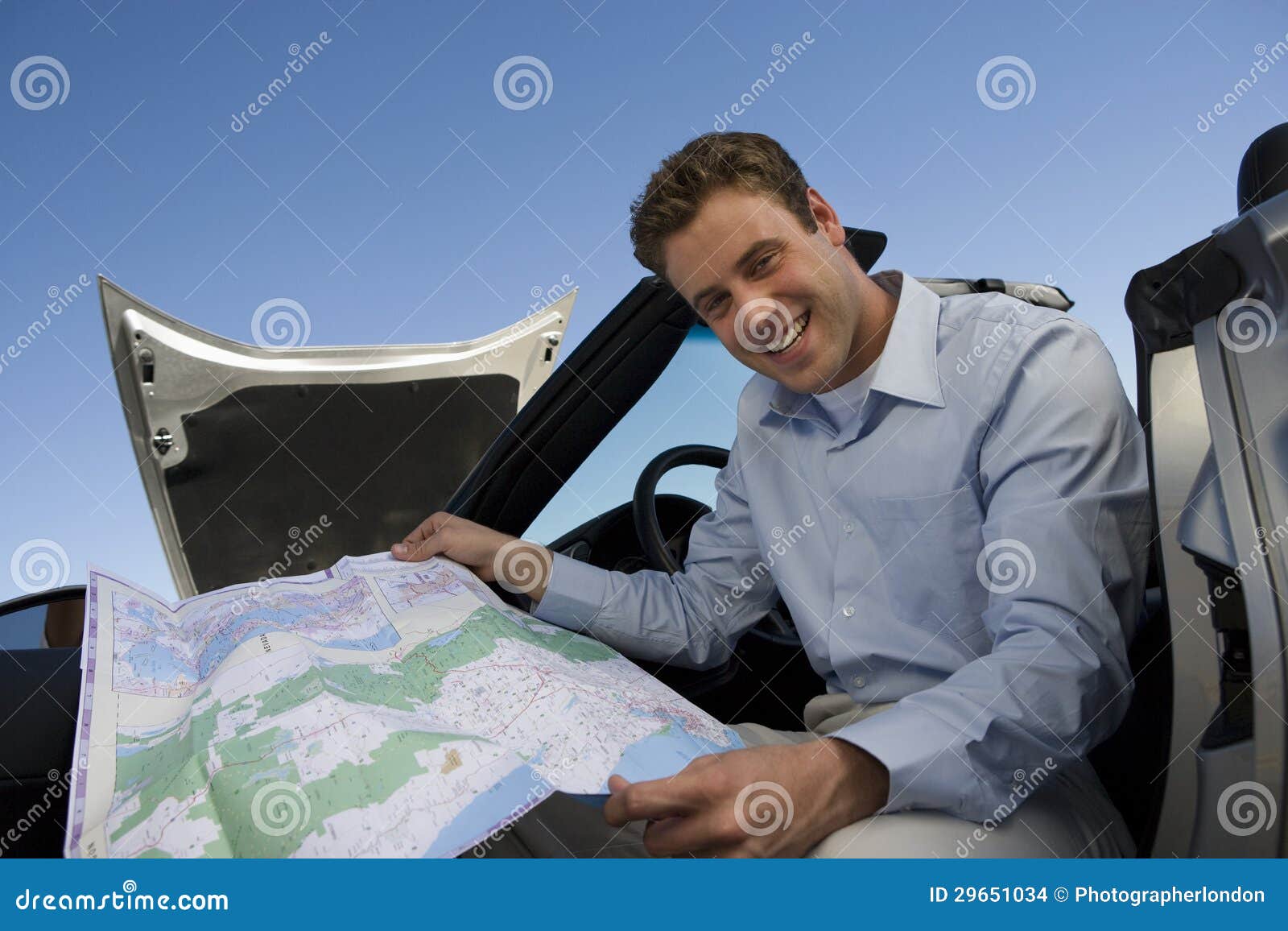 Man Holding Map while Sitting in Car Stock Photo - Image of ...