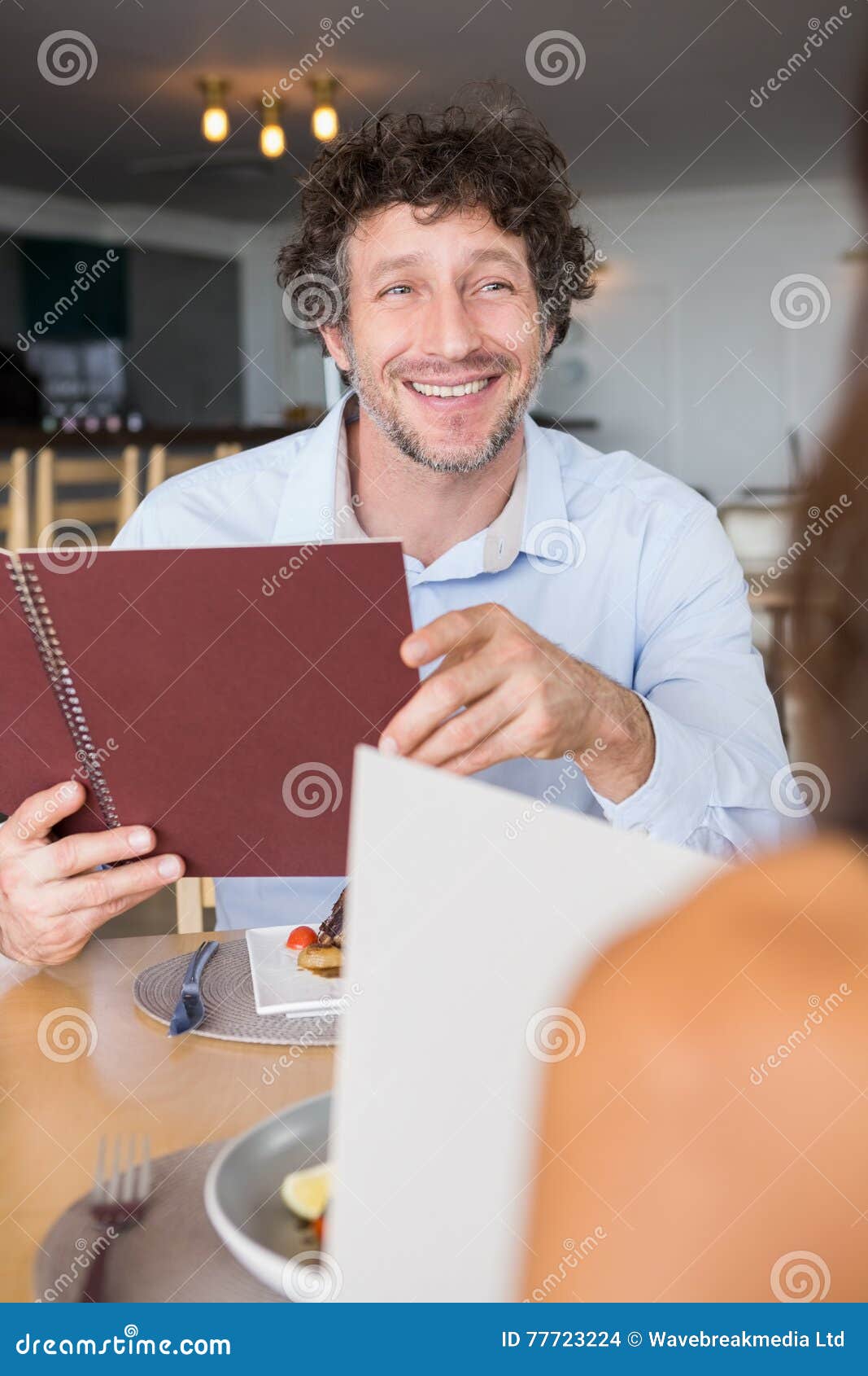 Man Holding Menu Card and Smiling Stock Photo - Image of indoors ...