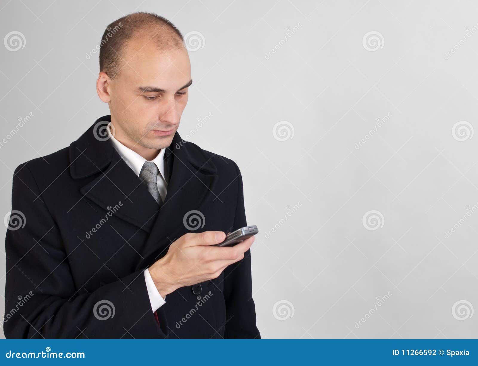 Man holding a mobile phone stock photo. Image of coat - 11266592