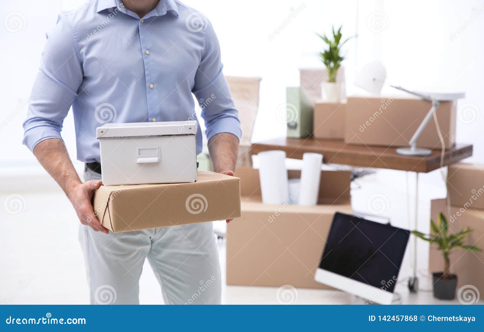 Man Holding Moving Boxes in New Office. Space for Text Stock Photo ...