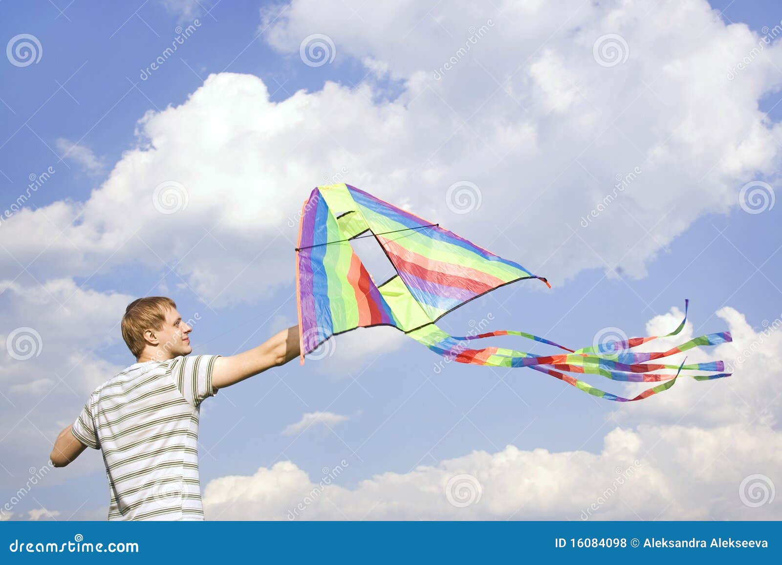 Man Holding Multicolored Kite and Looking on it Stock Photo - Image of ...