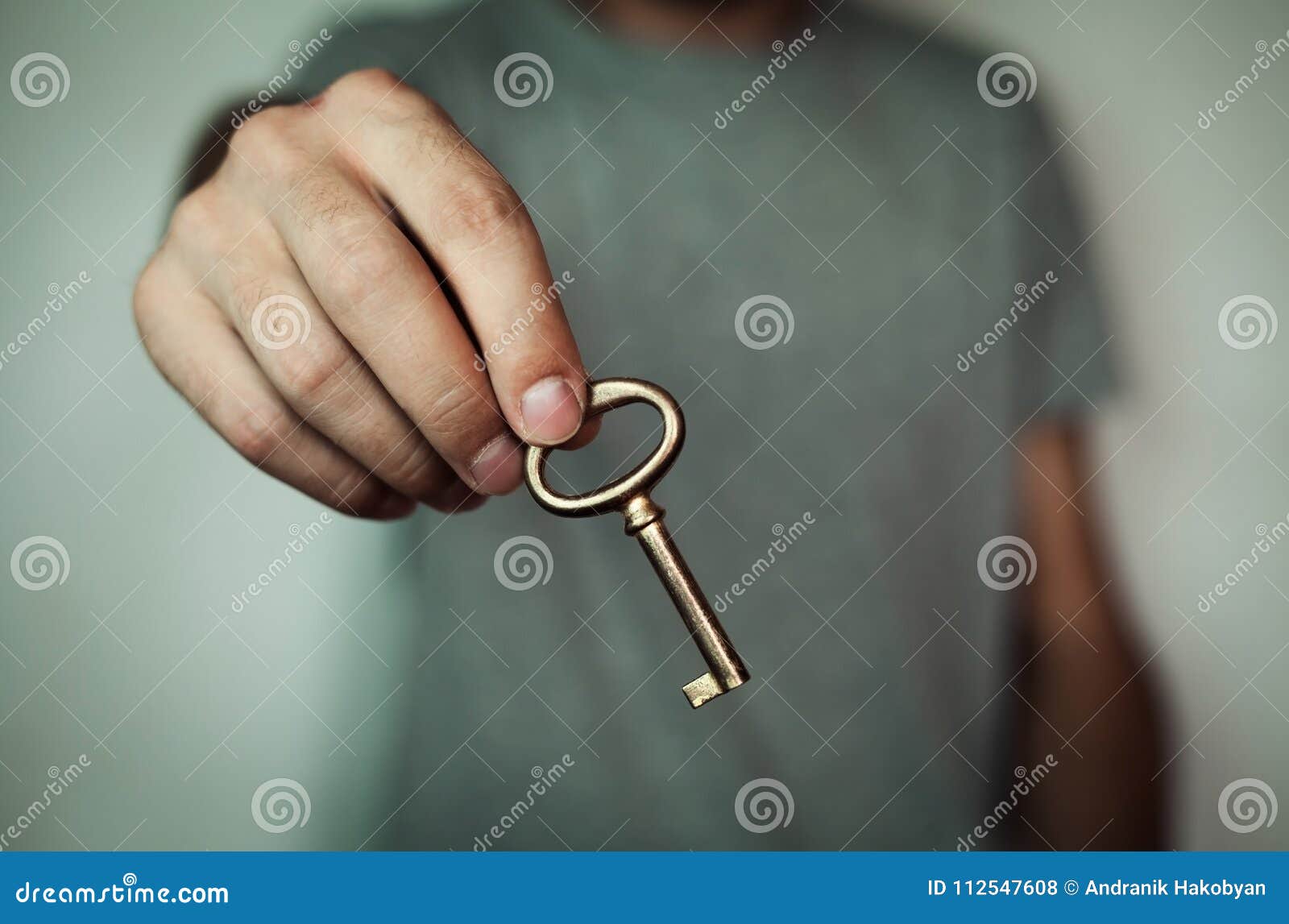 Man holding old key. stock photo. Image of security - 112547608