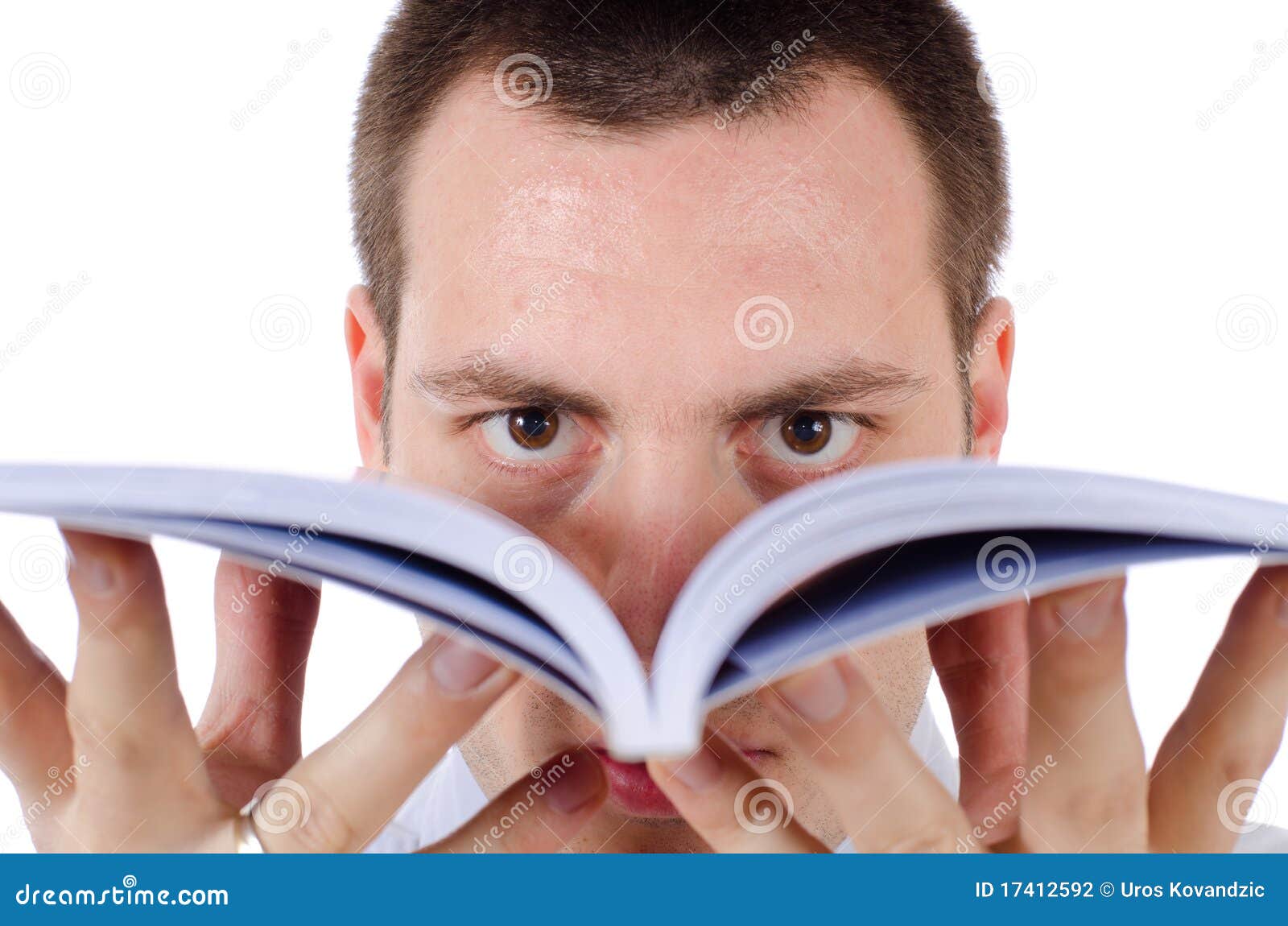 Man Holding an Open Book in Front of His Face Stock Photo - Image of ...