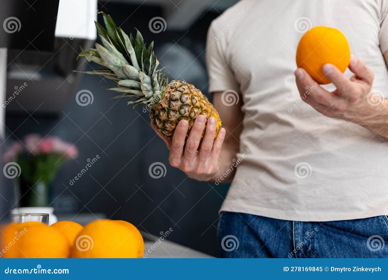Man Holding Orange Standing and Pineapple in Kitchen Stock Image ...