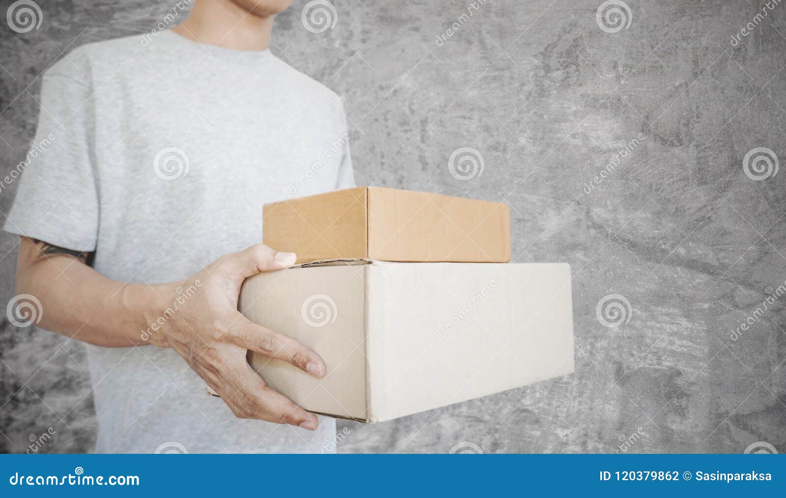 A Man Holding Parcel Boxes Package, on Concrete Texture Background ...