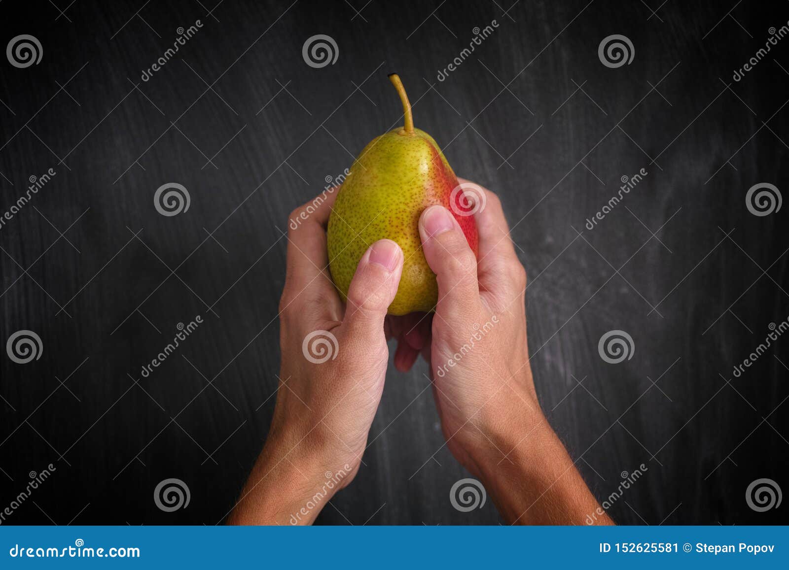 Man Holding Pear in His Hands Stock Image - Image of green, food: 152625581