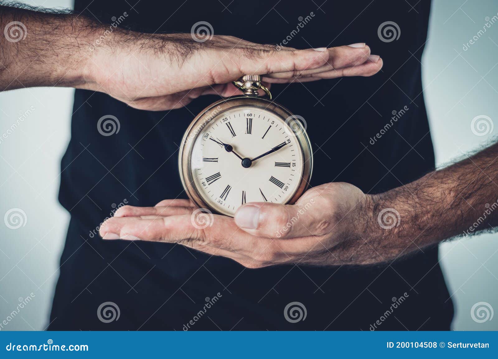The Man is Holding a Pocket Watch between His Two Hands. Time Concept ...