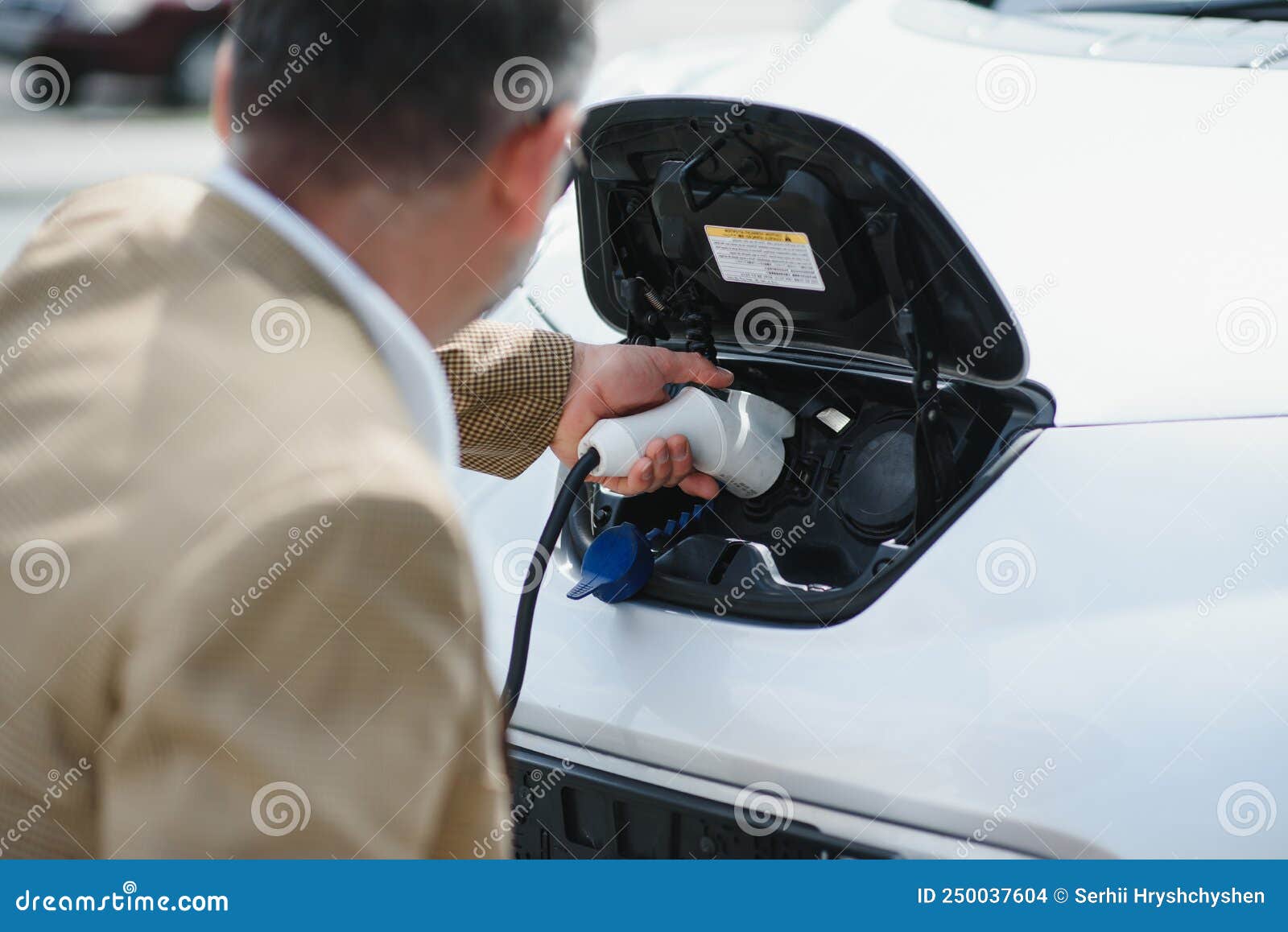 Man Holding Power Connector for Electric Car Stock Photo - Image of ...
