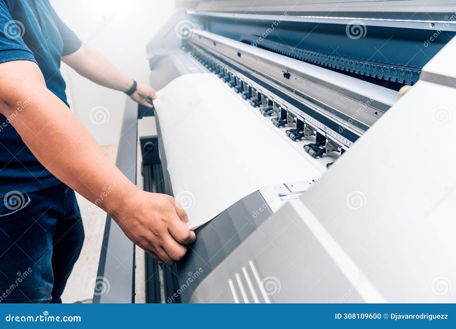 Man Holding Printable Material on Alarge Format Printing Plotter Stock ...