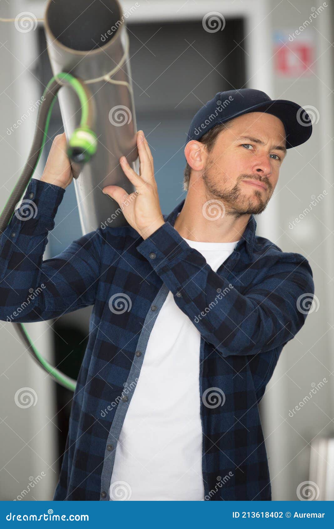 Man holding pvc pipe stock photo. Image of building - 213618402