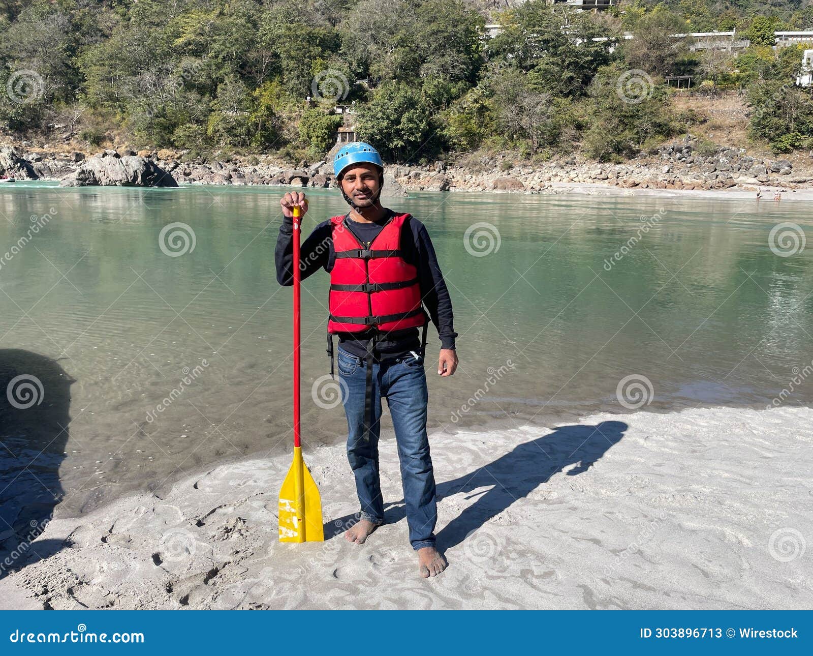 A Man is Standing by the Water Holding a Raft and Paddle Stock Image ...