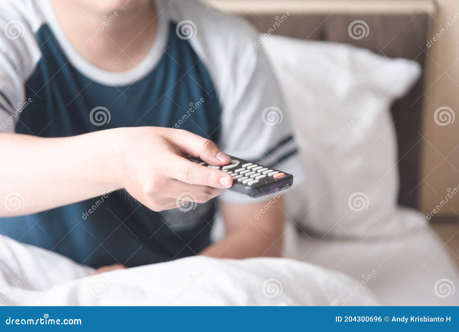 A Man Holding a Remote Control Stock Photo - Image of healthy, resting ...