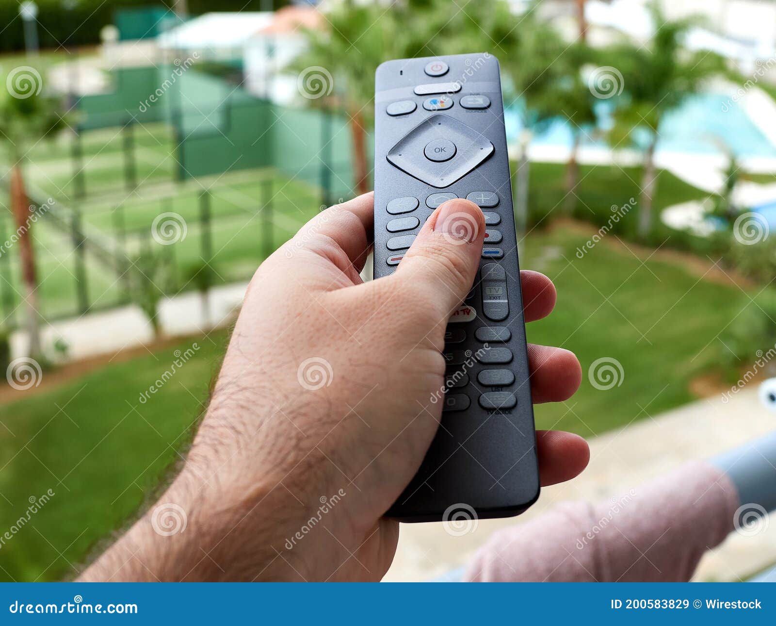 Man Holding a Remote Controller Near the Window Stock Image - Image of ...