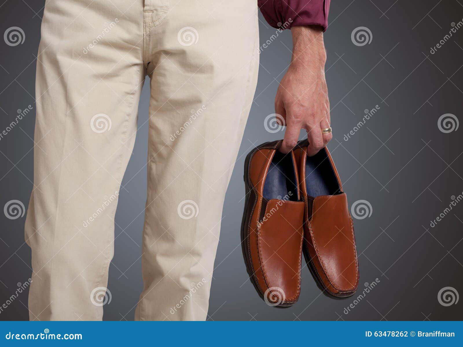 Man Holding Shoes Hand Stock Photos - Download 1,617 Royalty Free Photos