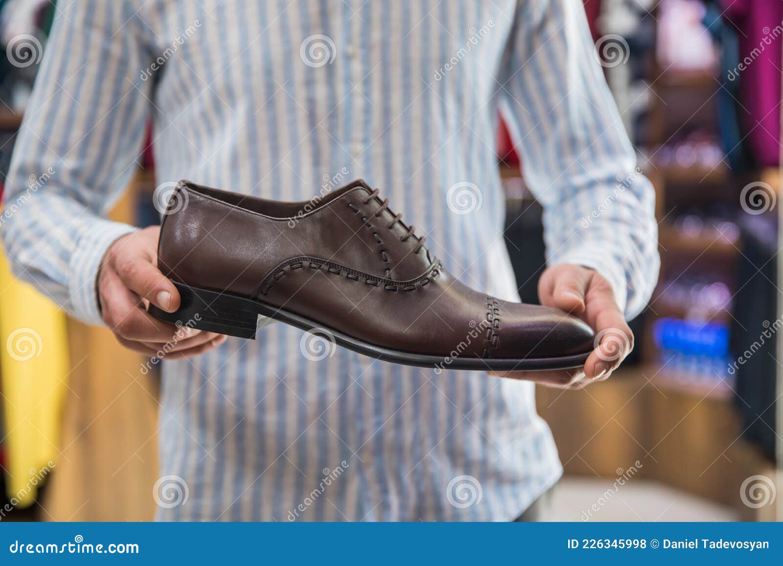 Man holding shoes in shop stock photo. Image of size - 226345998