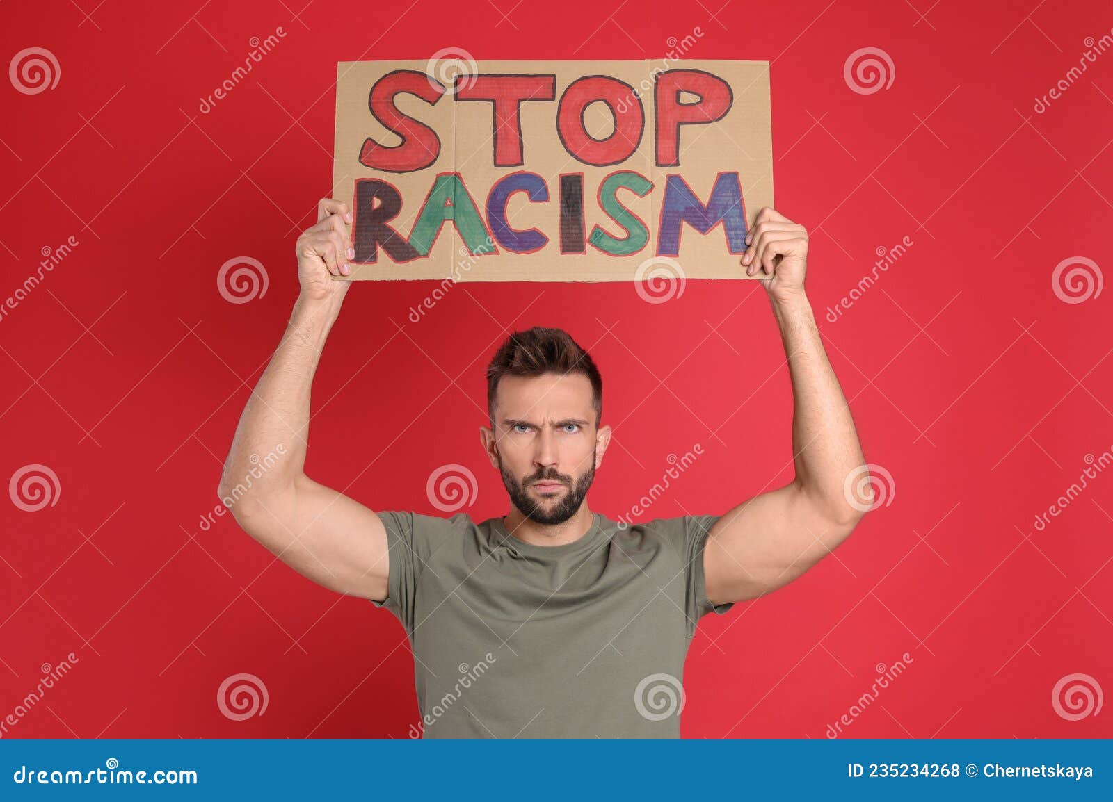 Man Holding Sign with Phrase Stop Racism on Red Background Stock Photo ...