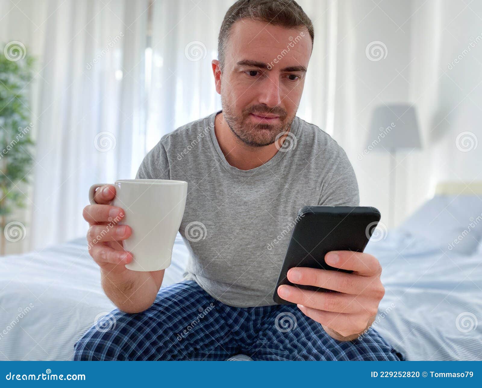 Man Holding Smartphone Early in the Morning Stock Photo - Image of ...