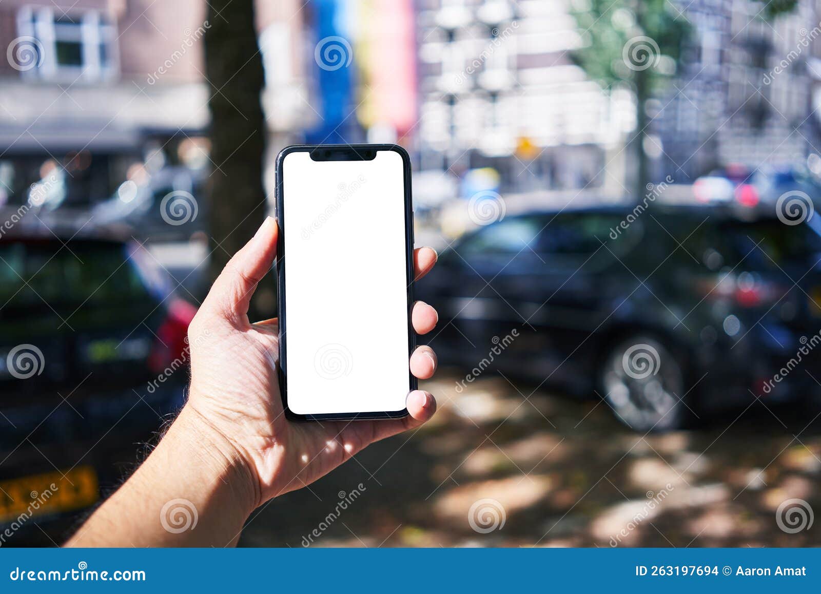 Man Holding Smartphone Showing White Blank Screen at Car Parking Stock ...